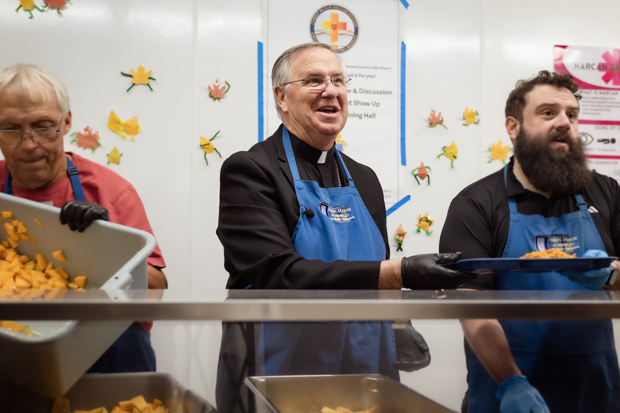 Bishop Dolan visits and serves at Andre House - The Catholic Sun